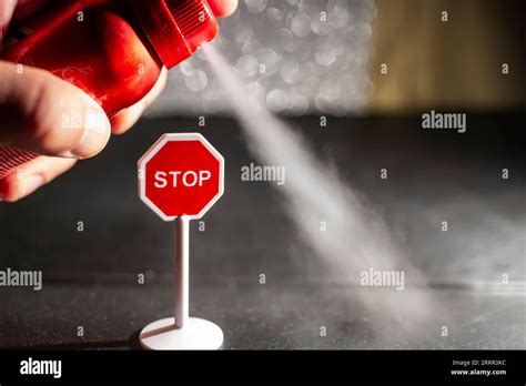 Using A Red Spray Can With Deodorant Against A Stop Sign Environmental Issue Concept Soft