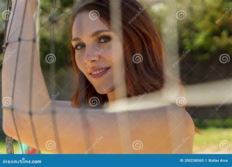 A Gorgeous Redhead Fitness Model Preparing To Play Volleyball Stock Photo Image Of Person