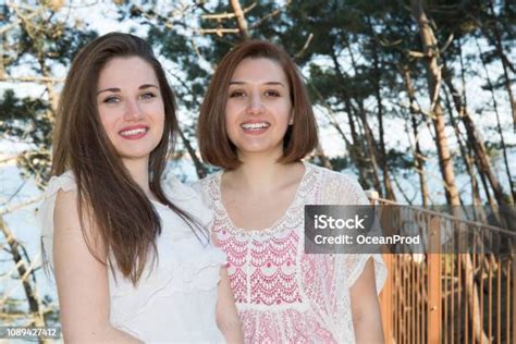 Smiling Girls Lesbian Couple Holding Hugging Each Other On The Beach