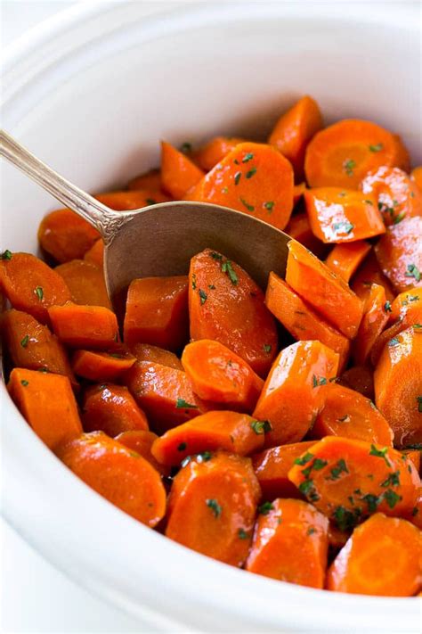 A Crock Pot Of Slow Cooker Carrots With A Serving Spoon In It Glazed Carrots Recipe Carrot