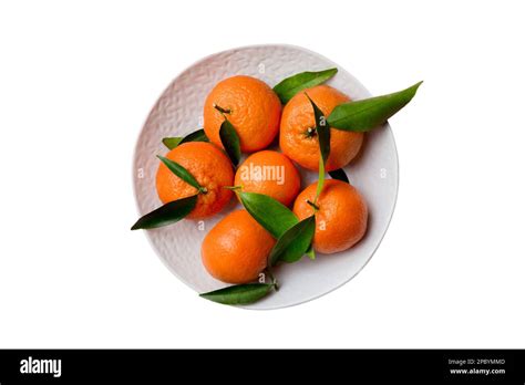 Fresh Cutted Clementines And Whole Mandarin Over Round Plate Isolated