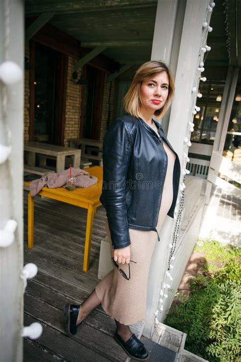 Beautiful Young Pregnant Woman Wearing Dress And Leather Shirt Resting