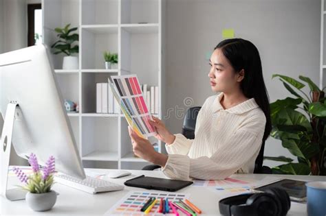 Female Designer Working In Graphic Design Choose Colors For Working On Tablets And Computer