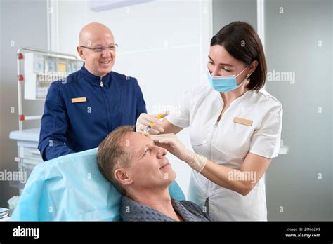 Mature Man Receiving Facial Plasma Injection At Modern Clinic Stock