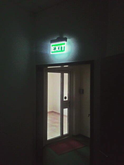 Premium Photo Illuminated Exit Sign On Entrance Of Building