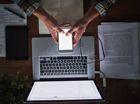 It Pays To Be Connected High Angle Shot Of An Unidentifiable Programmer Using His Laptop In The