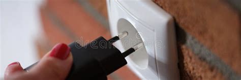Closeup Of Woman Holding Hand And Inserting Plug Into Socket Stock Photo Image Of Cellphone