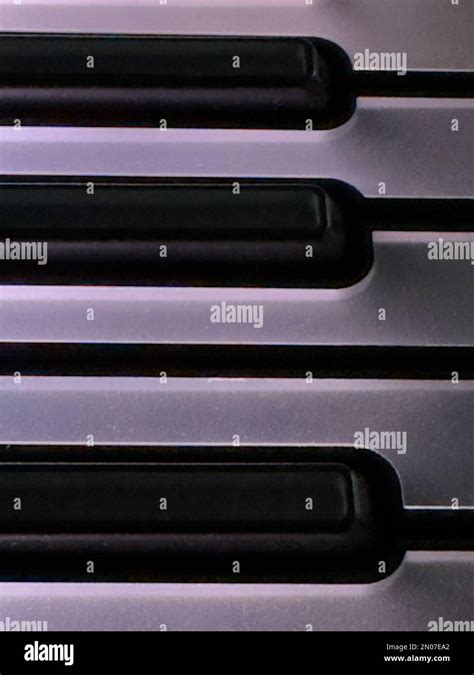 a detail of a colourful illuminated computer music midi keyboard