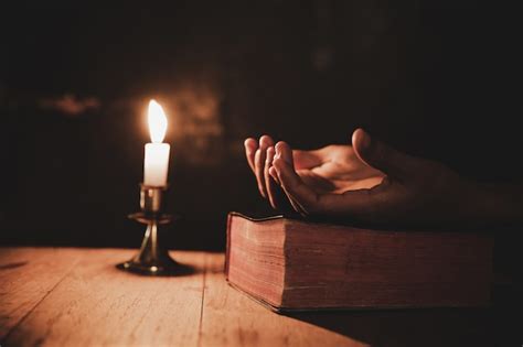 Free Photo Close Up Mans Hand Is Praying In The Church With Lit Candle