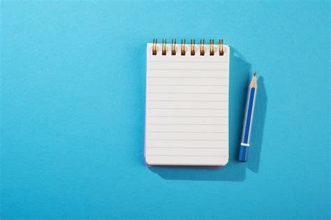 Premium Photo Single Lined Note Book And Pencil On Blue Background
