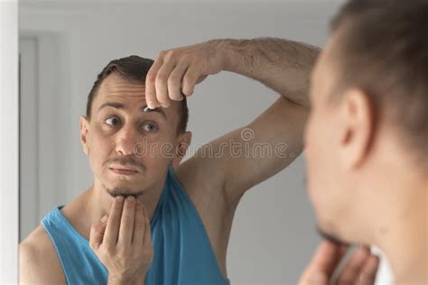 Middle Aged Man Does Facial Treatments In Bathroom Brunet Looks At