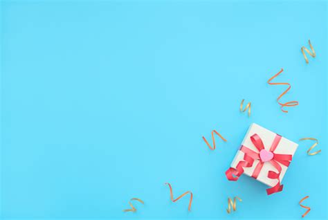 밝은 파티 스트리머와 파란색 배경에 빨간색 리본과 분홍색 하트흰색 선물 상자 어머니의 날 발렌타인 데이 결혼식 생일 개념 인사말 또는 초대 장 복사 공간이 있는 플랫 레이