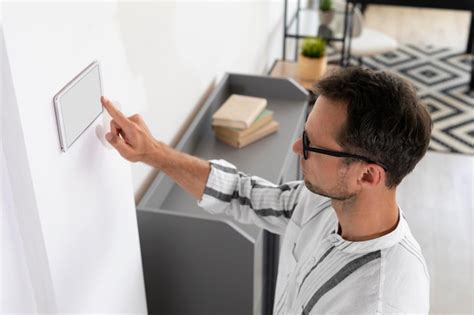 Premium Photo Man Using A Smart Home Tablet