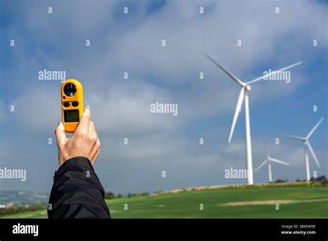 Engineer Measuring Wind Speed For Renewable Energy With Anemometer And