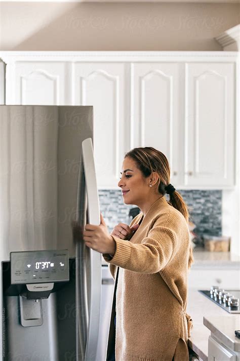 Kitchen Woman Peers Into Refrigerator By Stocksy Contributor Sean Locke Stocksy