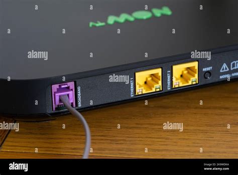 Macro Closeup Of The Back Of Wireless Broadband Internet Router With A Cable Plugged Into The