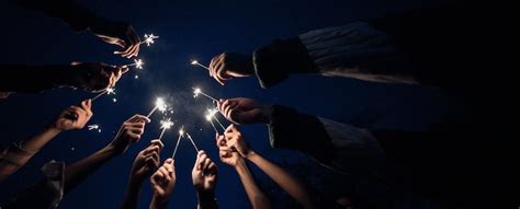 Premium Photo Selective Focus Hands Of People Holding Fire Burning Sparklers Blast To Playing