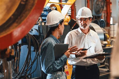 Factory Engineer With Assistant Using Laptop Inspect Factory