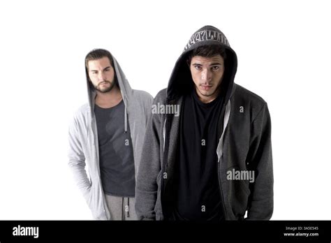 Two Seemingly Dangerous Thugs Standing Next To Each Other In Front Of A White Background Stock