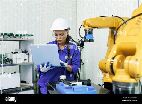 Female Automation Machine Engineer Student Study And Inspection Control Robot Arm Machine In