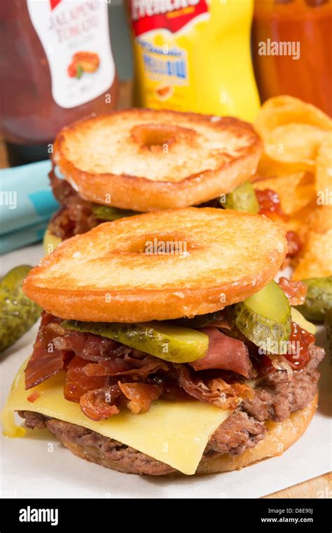 The Luther Burger A Beef Patty Cheese Crispy Bacon And Gherkins Between Two Halves Of A