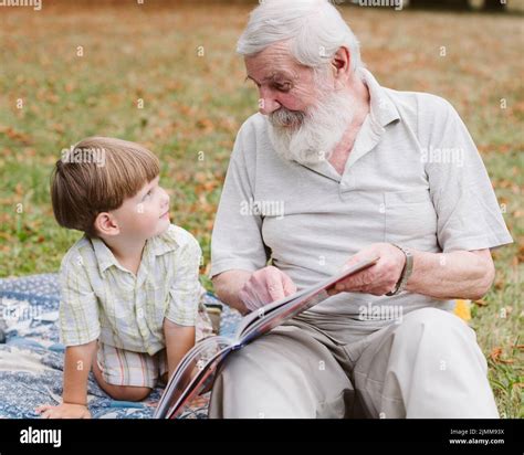 Grandpa Reading Grandson Park Stock Photo Alamy