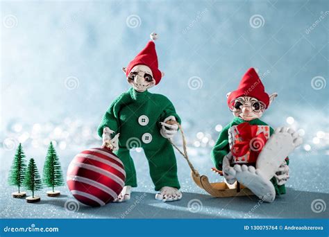 Cute Smiling Santas Helper Elves Holding Christmas Bauble And A