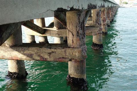 Concrete Pier Showing Signs Of Deterioration And Corrosion In Green