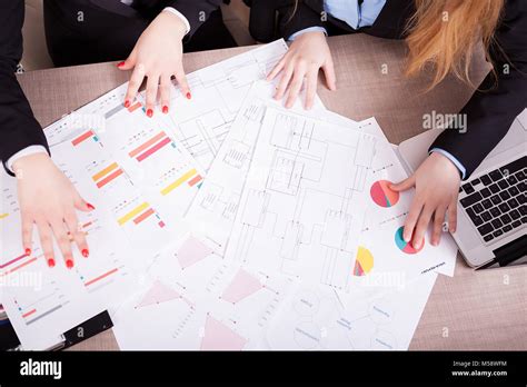 Two Women With A Lot Of Charts On The Table Stock Photo Alamy
