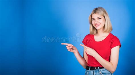 Young And Attractive Caucasian Blonde Girl In Casual Clothes Pointing