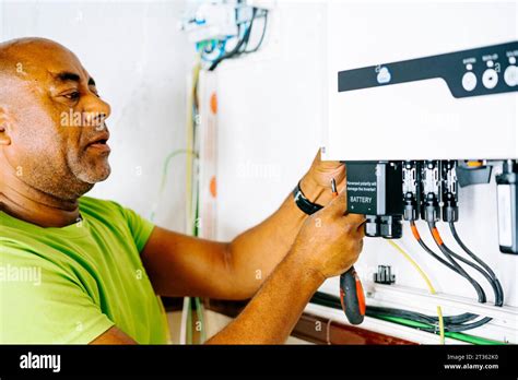 Mature Engineer Installing System In Utility Room Stock Photo Alamy