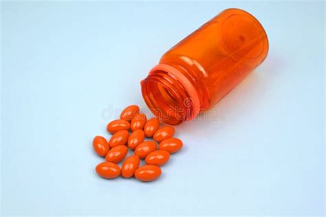 Orange Supplements Medical Pills Capsules And Tablets Spilling Out Of A