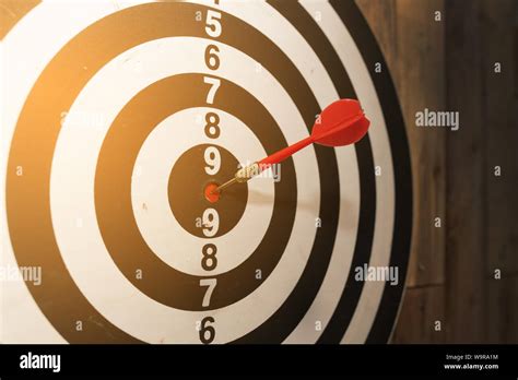 Red Dart Arrow Hitting In The Target Center Of Dartboard Stock Photo Alamy