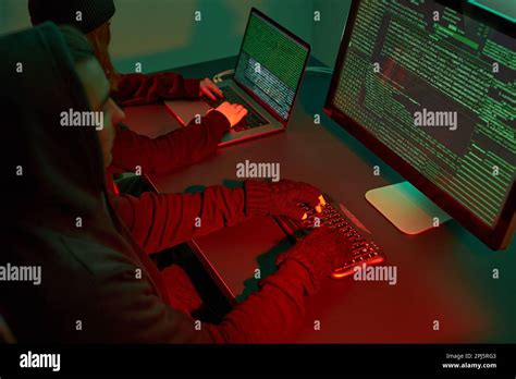 anonymous people using computer and programming to break code cyber