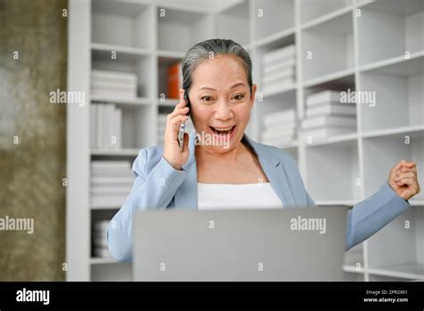 Happy And Overjoyed Senior Businesswoman Feeling Exited After Hearing A