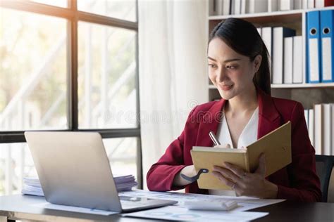 Girl Taking Note Book Eye On Laptop There Is Graph Data On The Table Stock Image Image Of