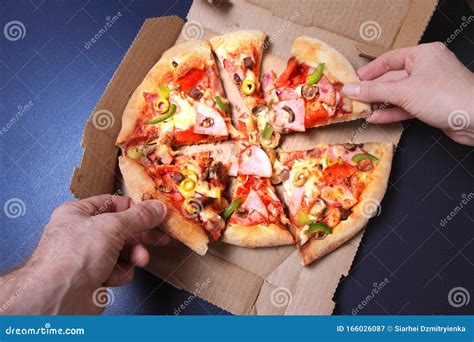 Hands Grabbing Slice Of Pizza Pizza With Prosciutto And Cheese Stock