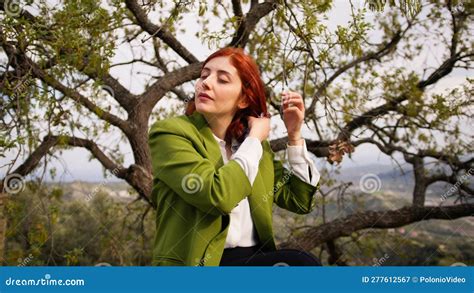 Girl Caresses Her Hair With Wisteria Flower In The Countryside Under