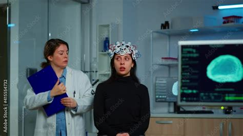 Neurological Doctor Cheking Eeg Headset Explaining To Patient Diagnosis Of Disease And Treatment