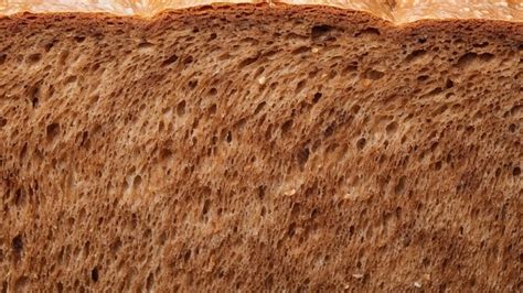 Close Up View Texture Of Brown Whole Wheat Bread Powerpoint Background