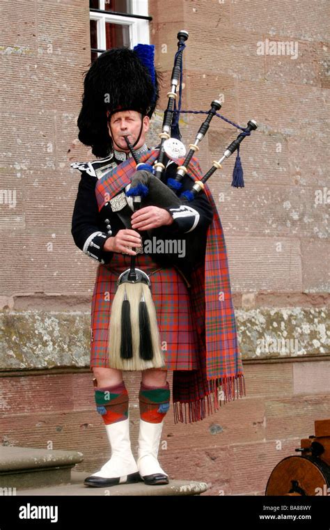 Scotland Scottish Man Playing The Bagpipe In Traditional Costume