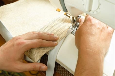 Premium Photo Male Hands Stitching White Fabric On Modern Sewing Machine Close Up View Of