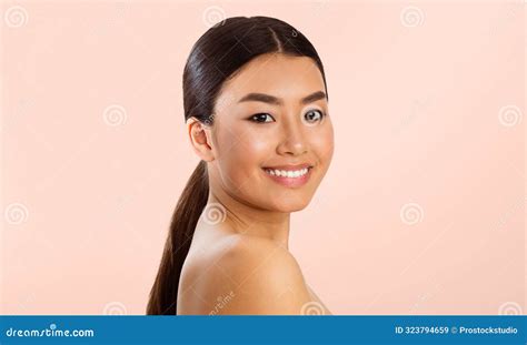 Smiling Woman With Long Black Hair Against Pink Background Stock Image