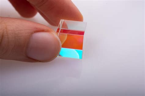 Premium Photo Optical Glass Cube In Hand Light Dispersionspectrum