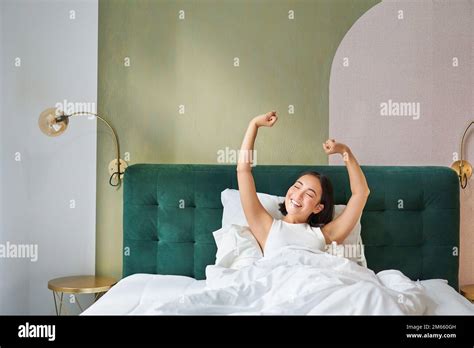 Portrait Of Smiling Happy Asian Girl Wakes Up Feeling Enthusiastic