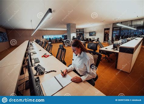 Female Security Operator Working In A Data System Control Room Offices Technical Operator