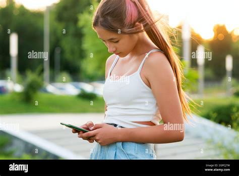 Teen Girl Uses Smartphone Emails Surfing Internet Always Connected Stock Photo Alamy