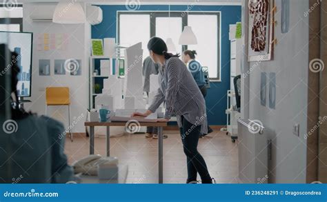 Woman Architect Designing Blueprints Plans With Building Model And Maquette On Table Stock Video