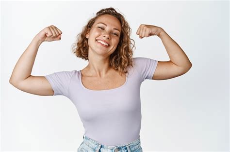 Premium Photo Women Power Smiling Pretty Girl Flexing Biceps
