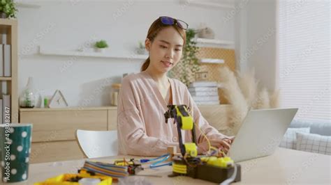 Video Stock Smart Asian Female Programer Learning Robot Arm Ai Coding
